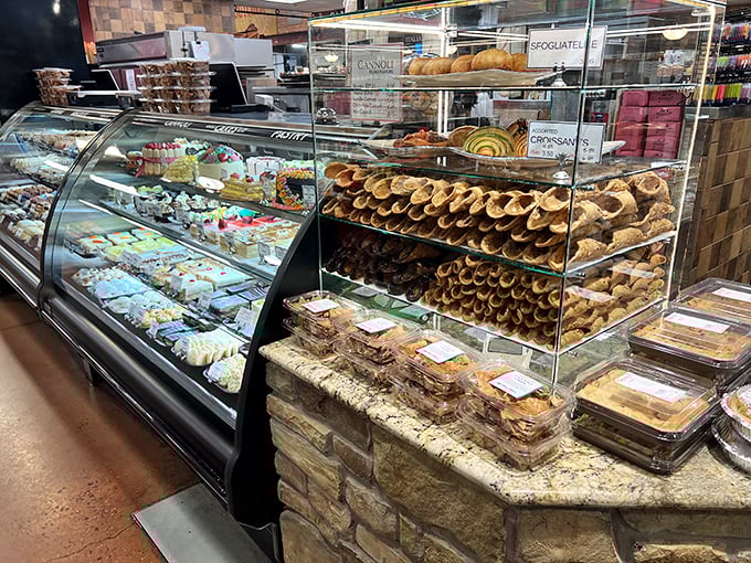 The pastry case and cannoli display—where willpower goes to die and happiness begins. Those cream-filled tubes are basically joy in edible form.