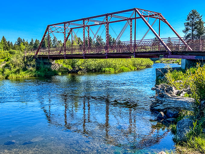 This rustic bridge spans more than just water—it connects you to Idaho's wilder side. Reflections double the beauty in this peaceful scene.