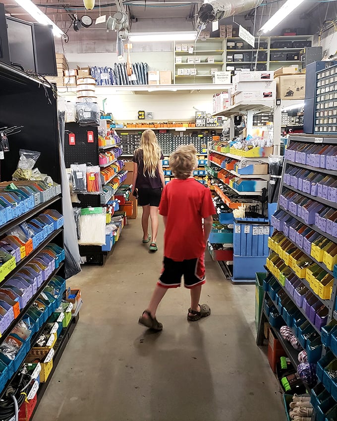 Young explorers navigating aisles of possibility. The next generation of inventors getting their first taste of surplus paradise.