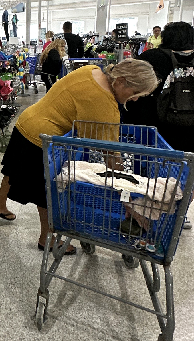 The treasure hunt in action. That focused expression says it all—she's not shopping, she's discovering.