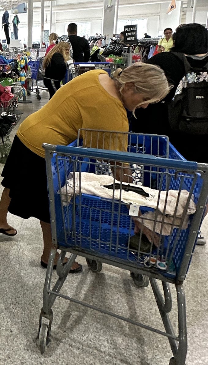 The treasure hunt in action. That focused expression says it all—she's not shopping, she's discovering.