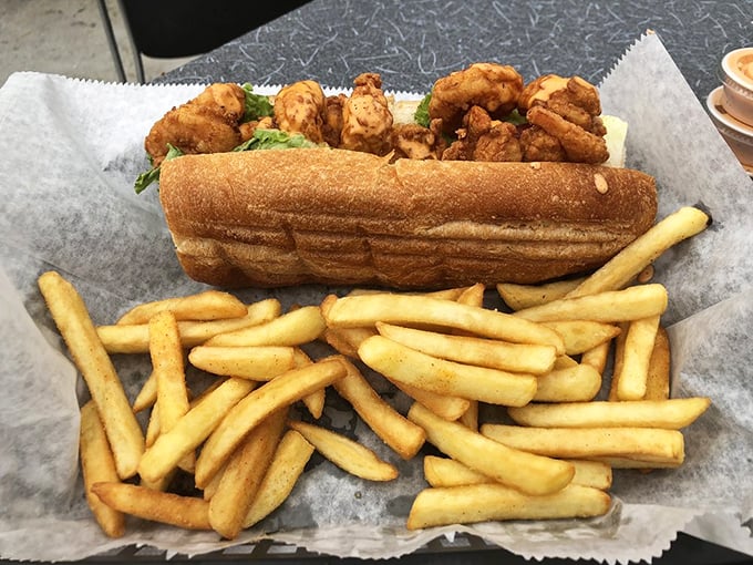 This po' boy is rich in flavor—crispy shrimp nestled in a perfect roll with a mountain of fries that demands to be devoured immediately.