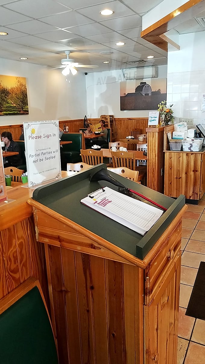 Please sign in—three words that stand between you and breakfast nirvana. The clipboard guardian of morning happiness.