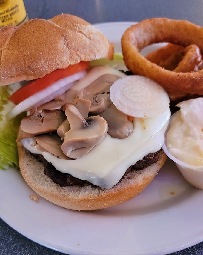 That burger brought mushrooms to the party because vegetables need representation too, even at a rib house.