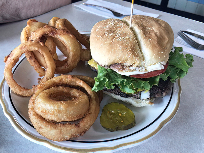 A proper diner burger comes with proper diner onion rings—architectural marvels of crispy, golden perfection.