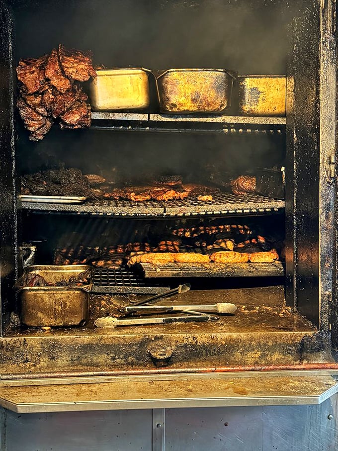 The smoke pit – where magic happens daily. Like watching Michelangelo paint, but with meat and fire instead of cherubs.