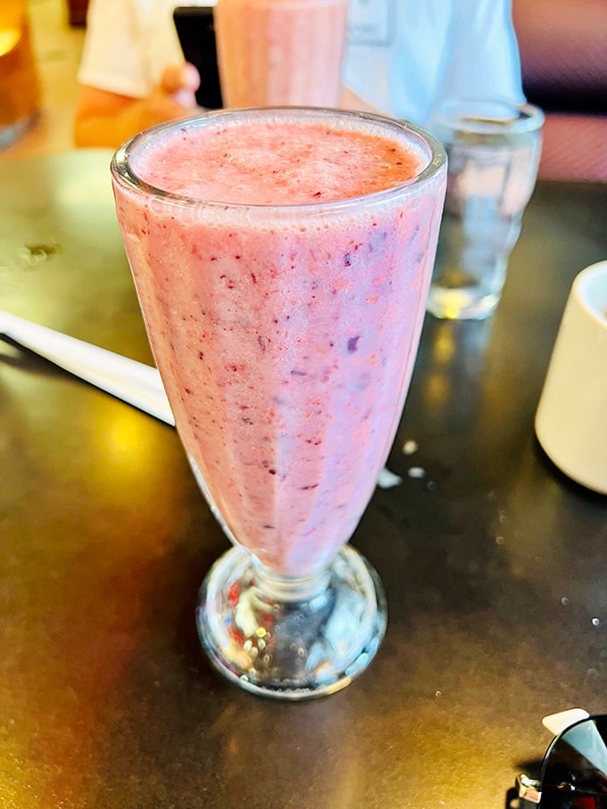The strawberry shake isn't just pink – it's the exact color of optimism, with real berries giving it a freckled complexion that's irresistibly photogenic.