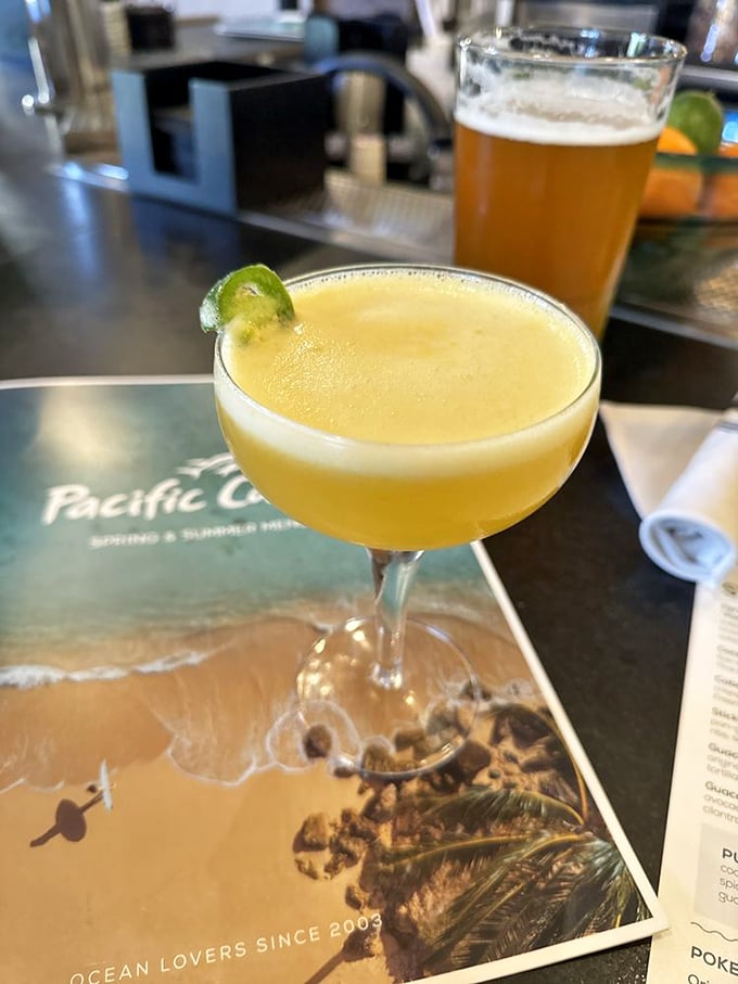 This golden elixir in a coupe glass isn't just a cocktail—it's liquid sunshine with a lime garnish. California in a glass.