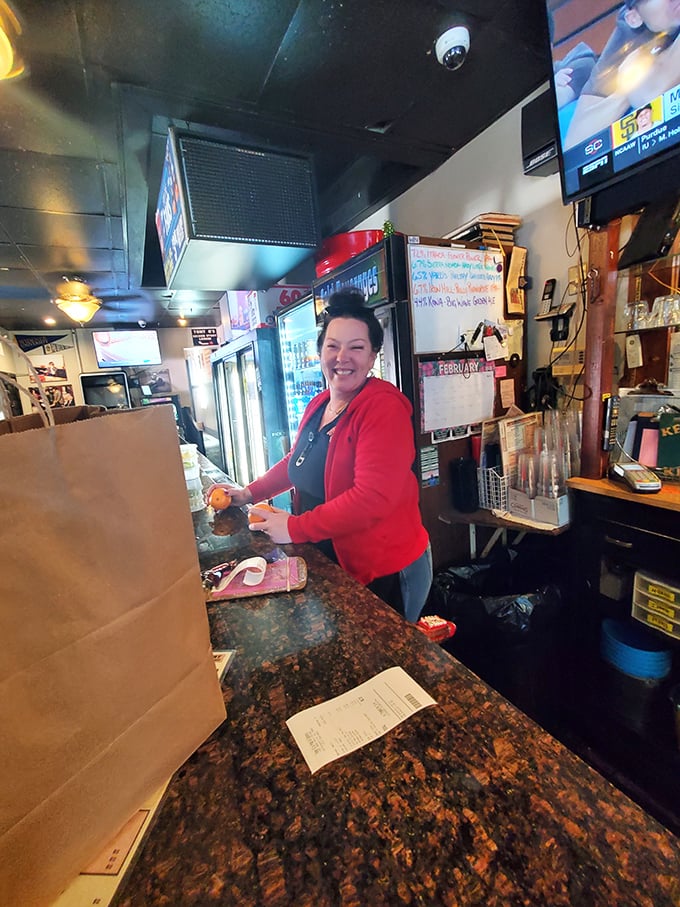 Behind the scenes where sandwich magic happens. The staff's smile says it all—they know they're creating memories, not just meals.