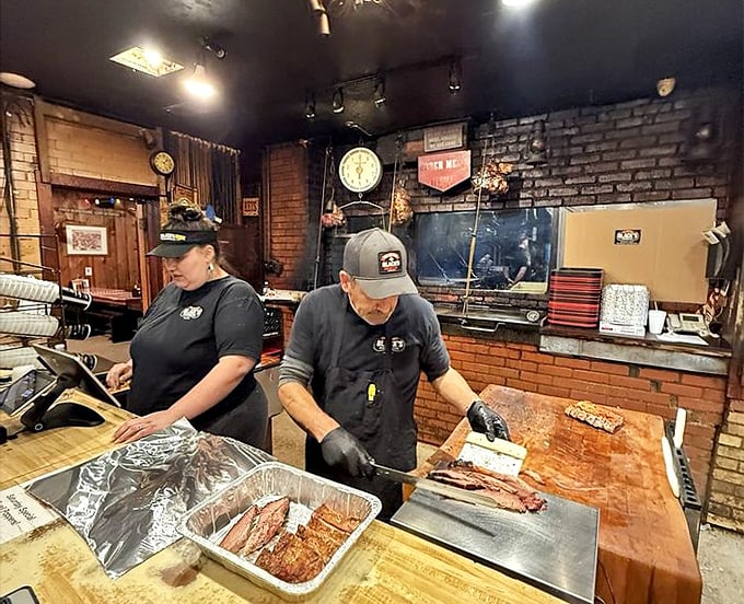 The pitmasters at work—watching them slice is like seeing Michelangelo with a chisel, except their masterpieces disappear within minutes.