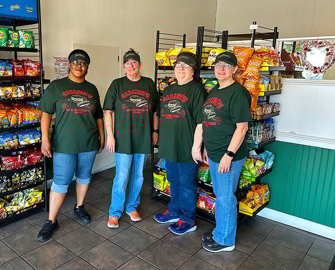 The team behind the magic, wearing their burger pride like superhero uniforms. These are the guardians of good taste.