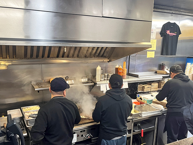 The sandwich artists at work, turning ordinary ingredients into edible masterpieces with surgical precision.