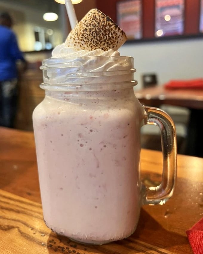 This isn't just a milkshake – it's dessert architecture, complete with a toasted marshmallow hat that's begging to be Instagrammed.