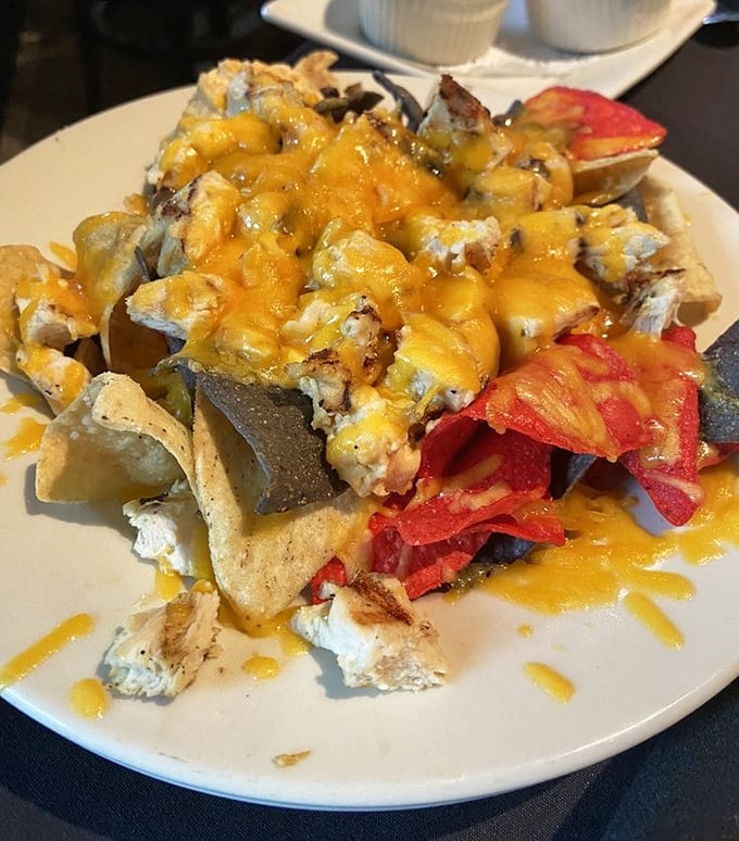 Nachos that defy gravity and good sense—a mountain of melted cheese, chips, and toppings that demands to be conquered.