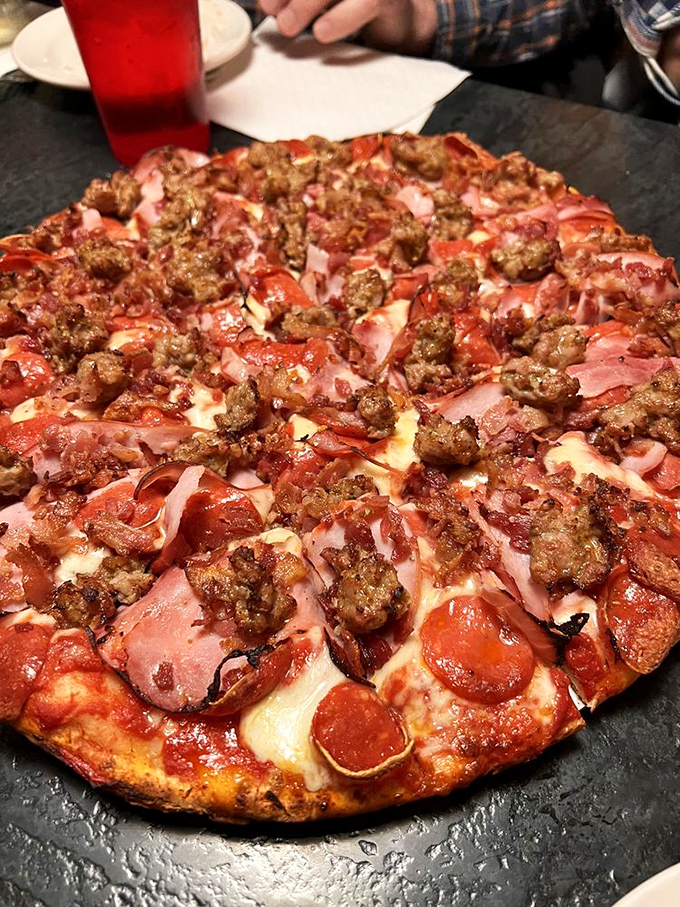 The Supreme Meat Pizza doesn't just have toppings—it has a carnivorous congregation celebrating atop a cheese altar. Vegetarians, avert your eyes.