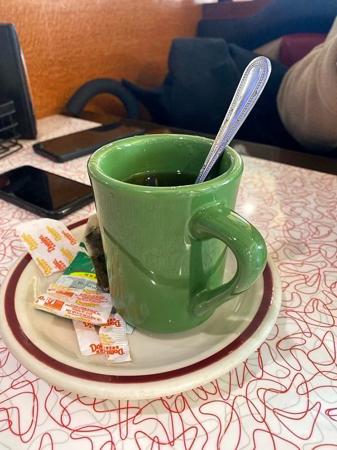 Even the coffee mugs have personality here—this cheerful green cup promises to turn any morning frown completely upside down.