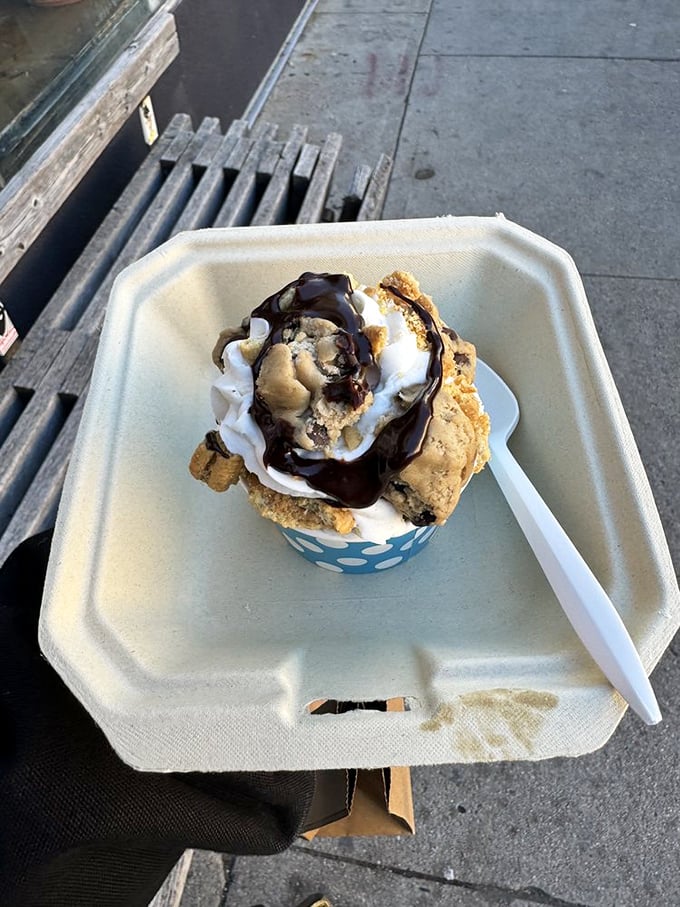 Sidewalk dining at its sweetest. This cookie dough creation with chocolate drizzle proves some of life's best moments happen on simple paper plates.