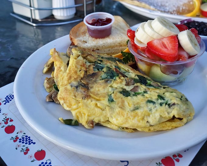 This omelet doesn't just contain vegetables – it showcases them like the headliners they are, with a side of fresh fruit playing perfect backup.