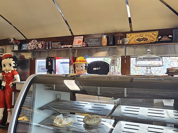 The dessert case guarded by vintage Betty Boop figurines – silent sentinels protecting pies that would make your grandmother both proud and jealous.