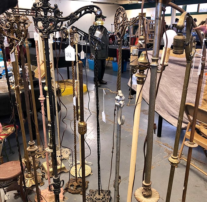 A forest of vintage floor lamps stands at attention, ready to illuminate your living room with mid-century charm.