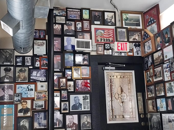 Not just decoration—a wall of honor showcasing military service, creating a dining room that feels more like a community living room.