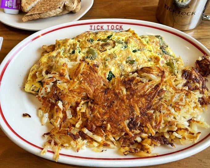 This isn't just an omelet—it's a golden canvas where hash browns and eggs perform a delicious duet that's worth getting out of bed for.