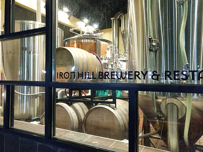 Behind glass walls, the alchemy of brewing unfolds. These barrels hold liquid treasures that transform ordinary evenings into memorable occasions.