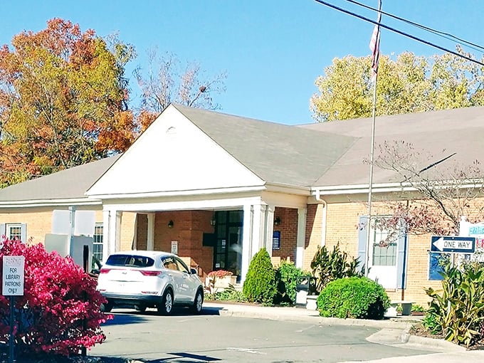 The Wythe County Library welcomes readers with a modest entrance and vibrant landscaping—proof that literary adventures remain one of retirement's best bargains.