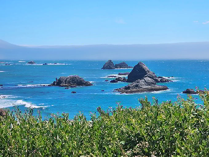 The Oregon coast's famous sea stacks create a jagged silhouette against the blue horizon, like nature's own abstract sculpture garden.