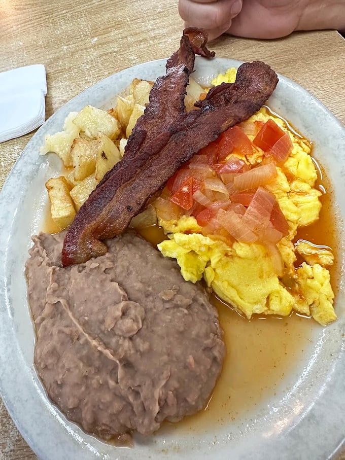 Bacon, eggs, and beans—the holy trinity of Tex-Mex breakfast, arranged with the casual confidence of a place that knows what works.