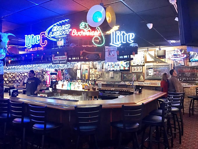 The bar area glows with neon nostalgia, a beacon for locals seeking cold drinks and warm conversation after long workdays.