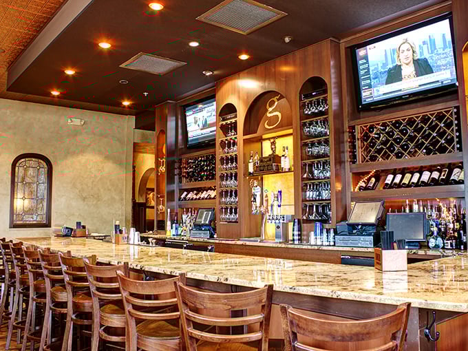 The bar at Giammarco's—where wine bottles stand at attention like soldiers guarding the gateway to a night of poor decision-making and excellent eating.