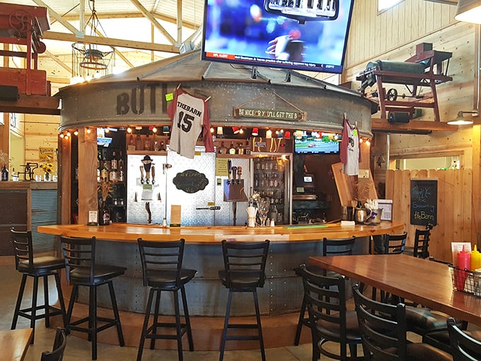 The bar area, crowned with corrugated metal, serves as command central for libations that complement The Barn's hearty fare.