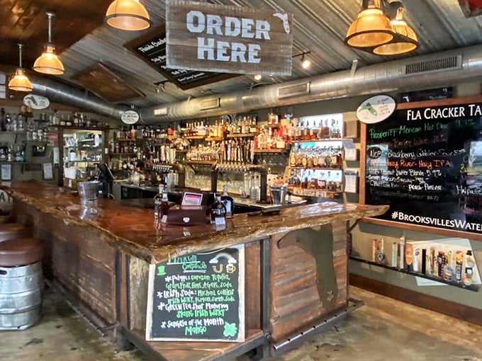 The bar area—where "ORDER HERE" is less a command and more an invitation to join the Florida Cracker community.