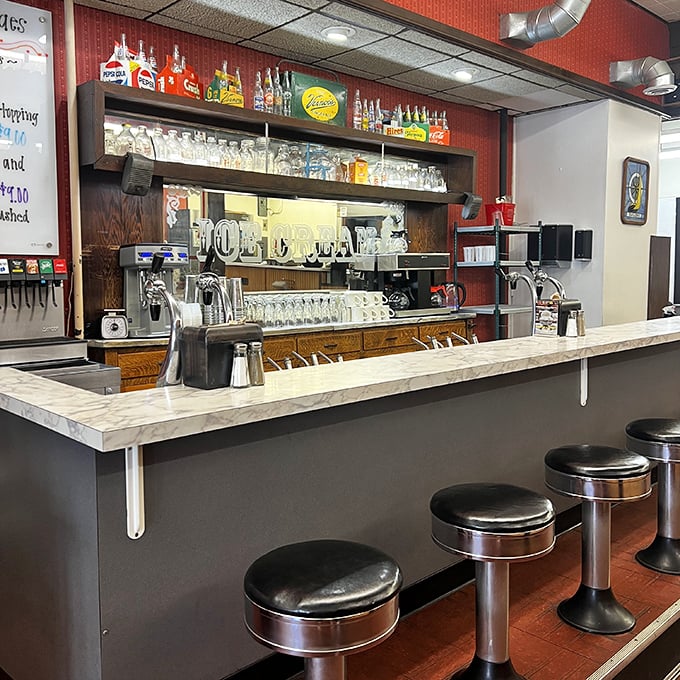The soda fountain counter—where magic happens one milkshake at a time. Those stools have supported generations of sweet-toothed dreamers. 
