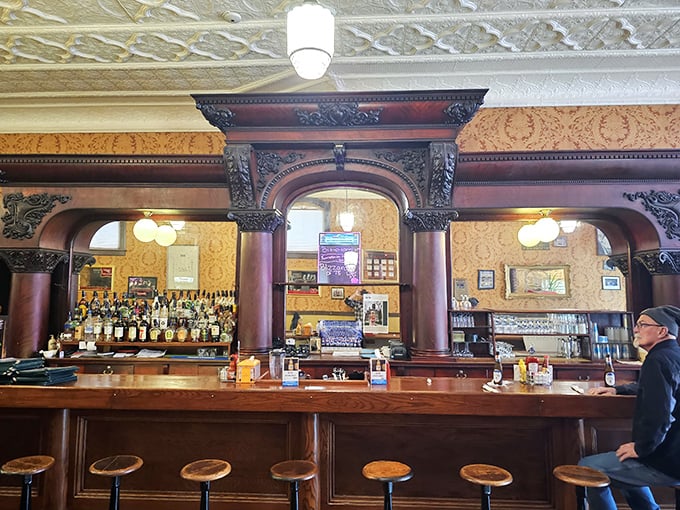 The bar's magnificent woodwork and ornate columns weren't built for Instagram—they were built to last through prohibition and beyond.
