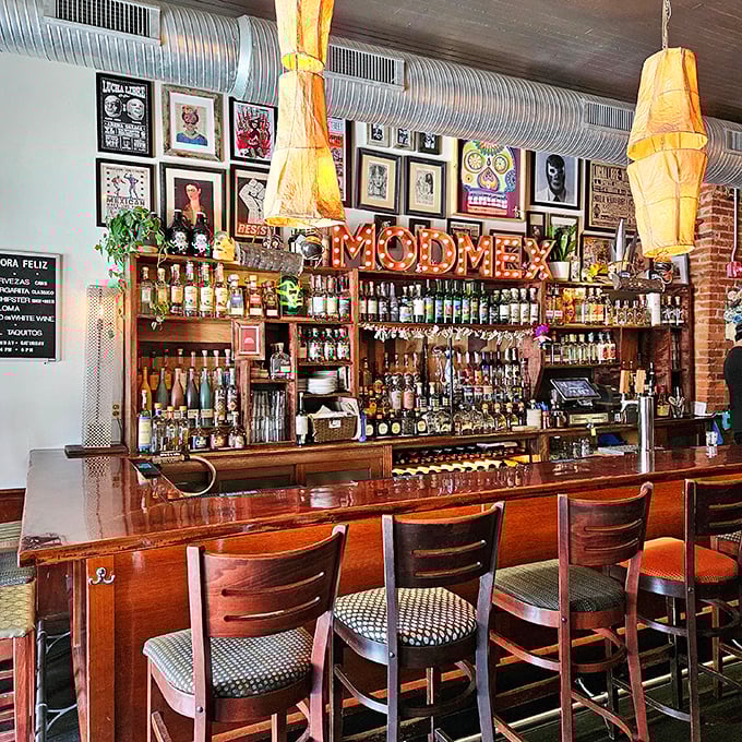 The bar area screams "mod Mex" with its illuminated signage, impressive spirits collection, and walls that double as a cultural scrapbook.