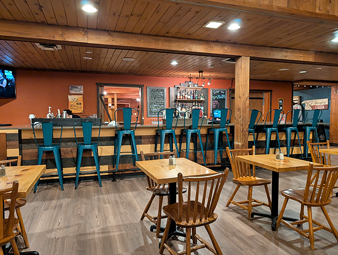 The bar area beckons with turquoise stools and wooden accents – a perfect perch to contemplate your next barbecue adventure.