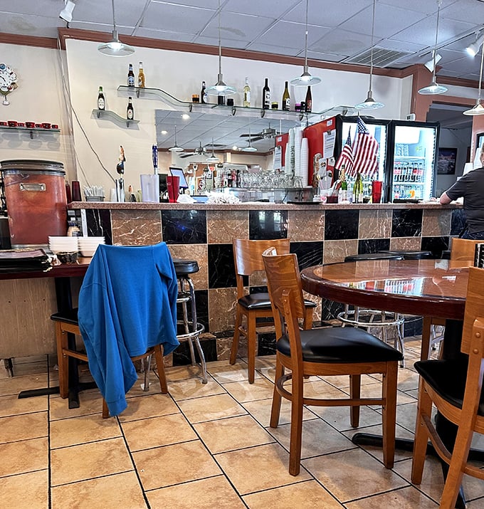 The checkered bar backdrop adds a touch of retro charm, while wooden chairs invite you to settle in and stay awhile—maybe for dessert?