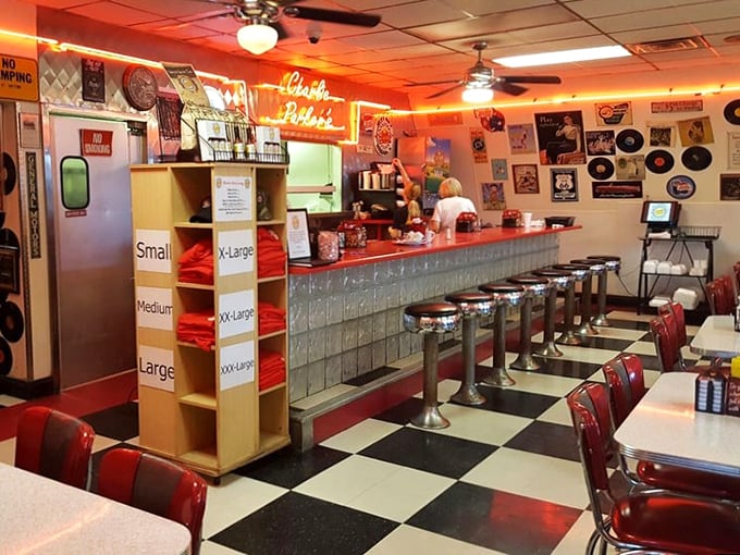 The counter—half glass block fortress, half front-row seat to breakfast theater—where regulars perch like birds on a wire, watching their meals materialize.
