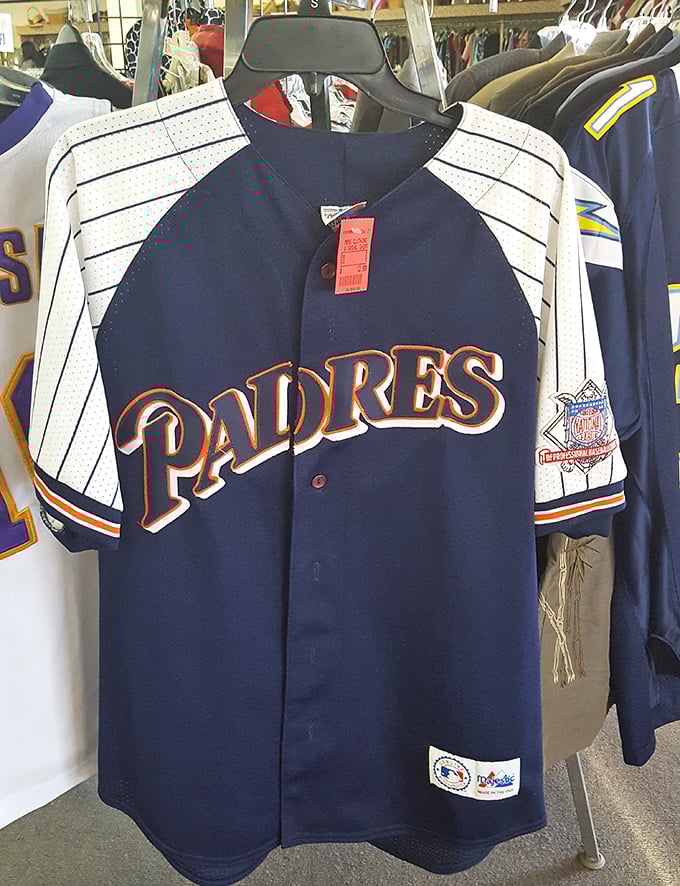 A pristine Padres jersey hangs hopefully, still bearing its original tag—proof that sometimes thrift stores offer brand new treasures among the pre-loved gems.
