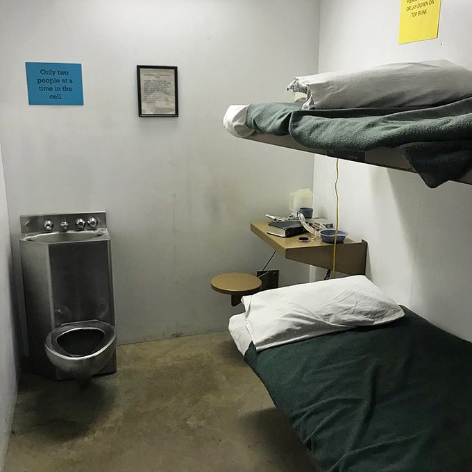 The stark reality of prison life hits home in this recreation of a standard cell—claustrophobic, utilitarian, and deliberately devoid of comfort.