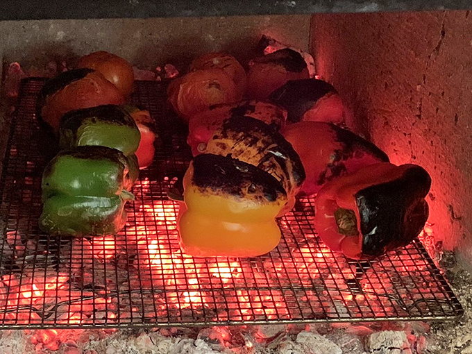 Behind every great barbecue joint is a fire—these peppers roasting over open flames are about to become something magical.