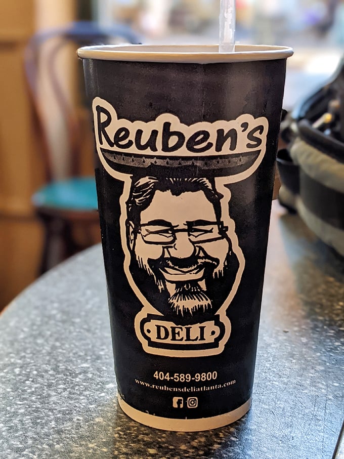 Even the cups have personality here – branded vessels of caffeinated joy to fuel your sandwich adventures.