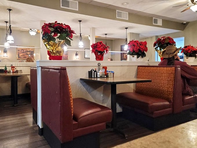 Booth seating adorned with festive poinsettias—comfort and joy served alongside your breakfast favorites. A cozy corner to start your day right.