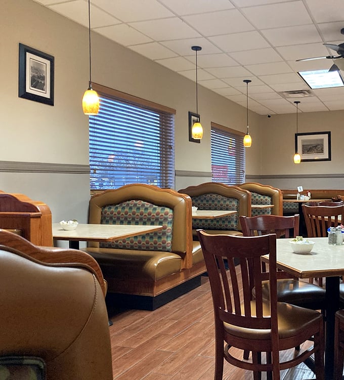 Cozy booths bathed in warm pendant lighting create the perfect backdrop for both first dates and fiftieth anniversaries. The wood paneling isn't retro – it's timeless.