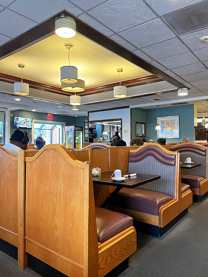 Classic diner booths where countless family stories have unfolded over pancakes and coffee. The high-backed dividers create little islands of conversation.