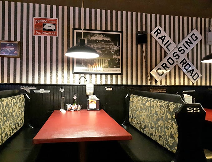 These booths, with their railroad-themed décor, invite you to settle in for the long haul. The "Rail Crossing" sign is appropriate—you're about to be hit by flavor.