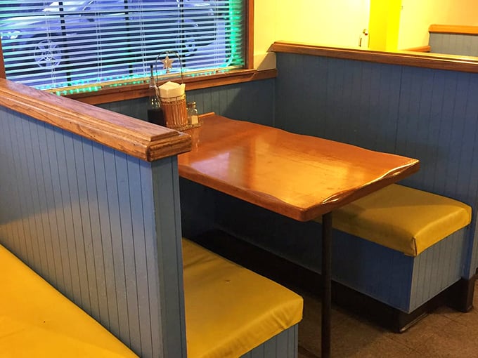 Cozy booths with those unmistakable yellow cushions – the kind of comfortable seating that invites you to linger over just one more hush puppy.
