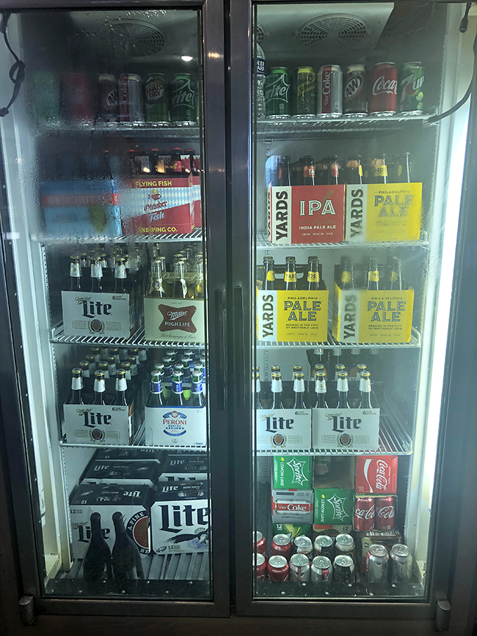 The beverage cooler – where local craft brews from Yards Brewing Company share real estate with national favorites, ensuring no thirst goes unquenched.